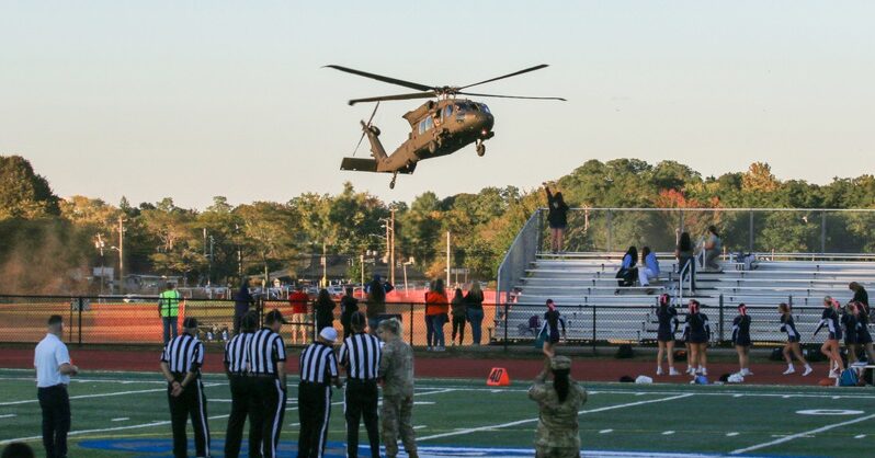 High School Football Players Battle for Loose Ball Dropped from ...